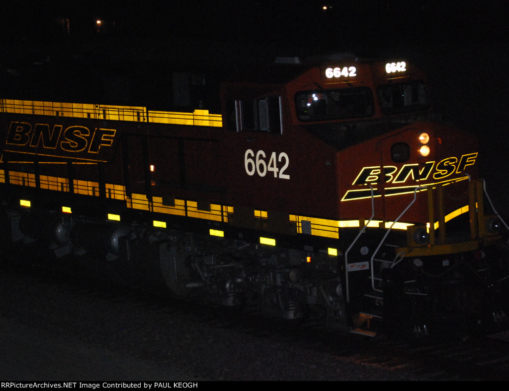 BNSF 6642's BNSF Swoosh Logo and LED roadnumber lights stand out in this night flash shot as she ...